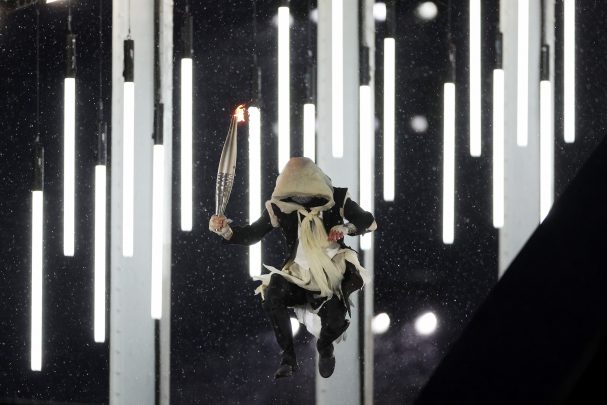 Who is the masked torchbearer 'parkouring' across Paris at Olympics ...